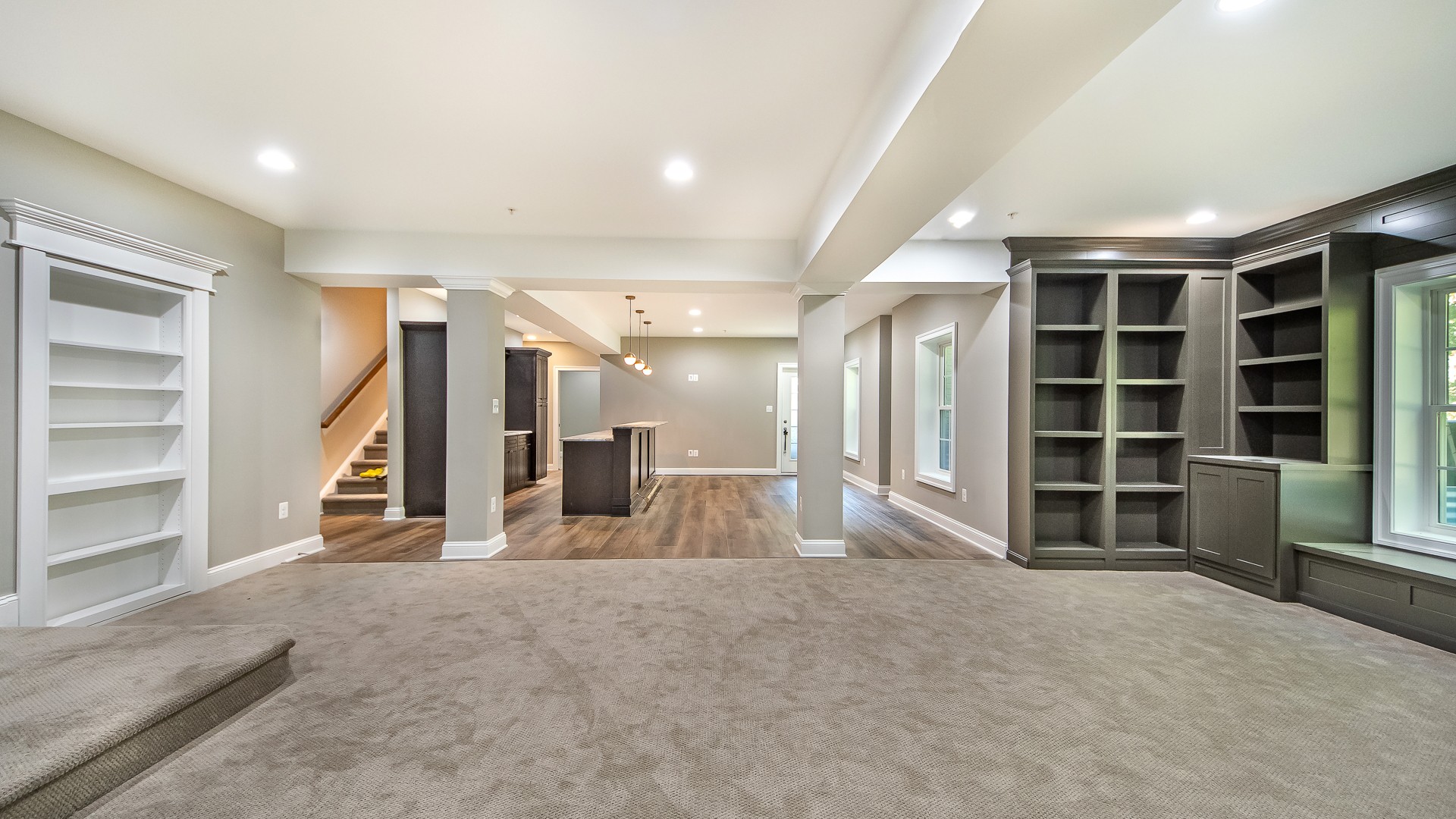 Large basement finishing with wet-bar and built-ins.