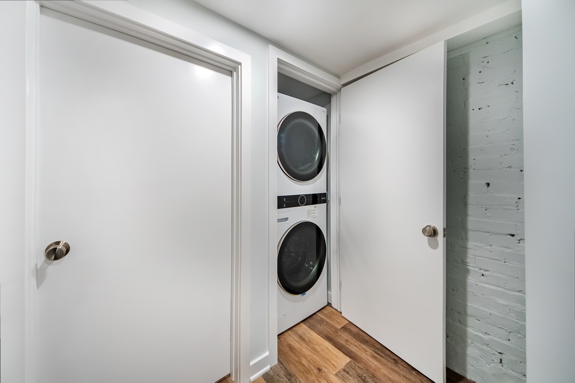 Finished Basement with a kitchen and exposed brick walls.