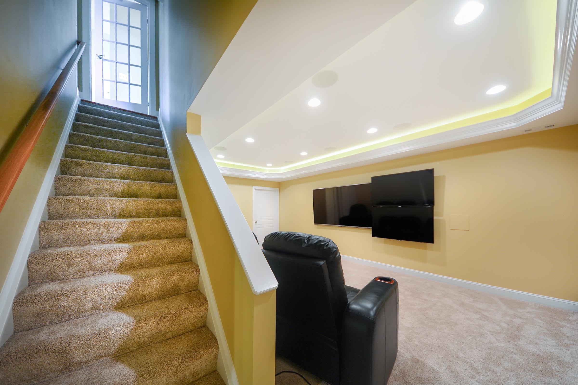 Basement TV Setup in A Yellow Home Theater