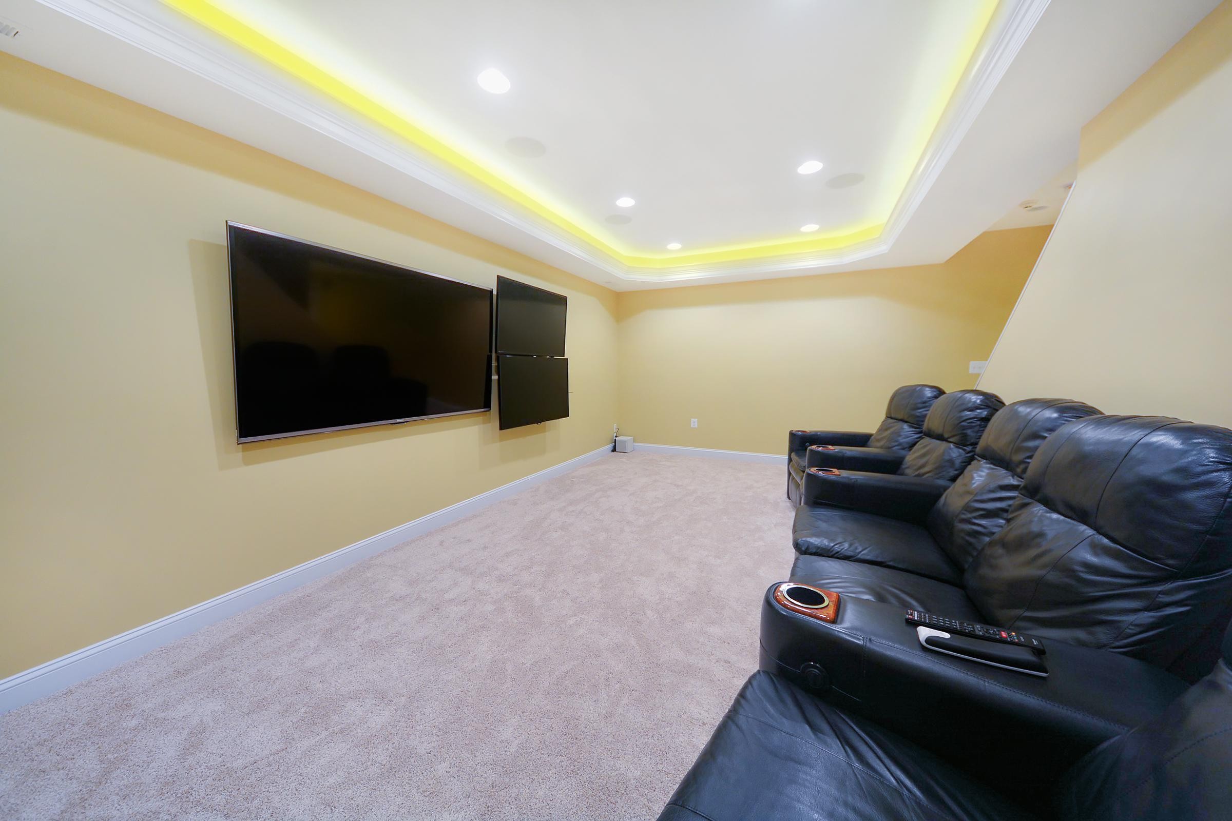Basement TV Setup in A Yellow Home Theater
